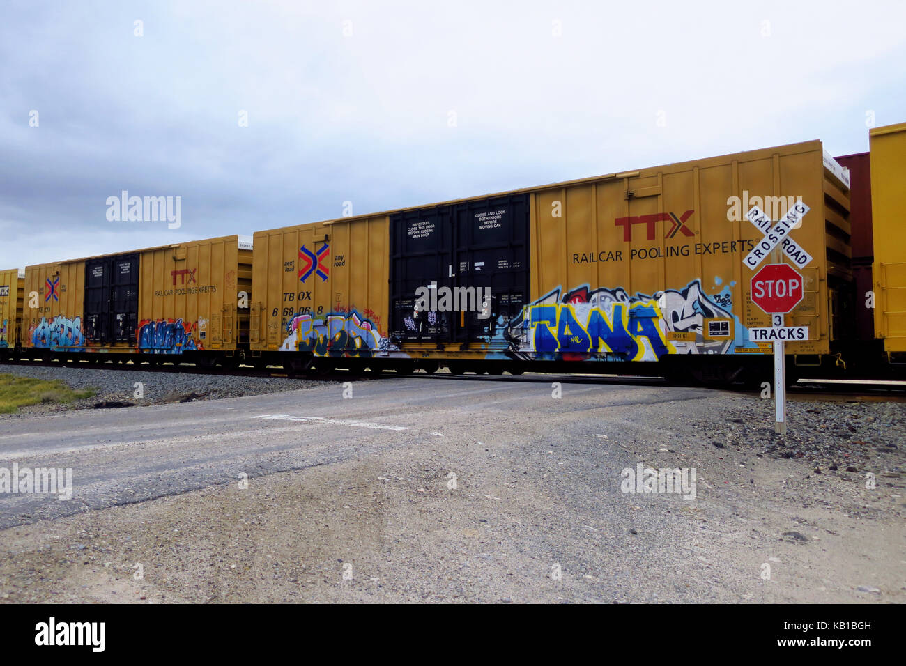A cargo train trailers at a railroad crossing on a gray sky Stock Photo ...