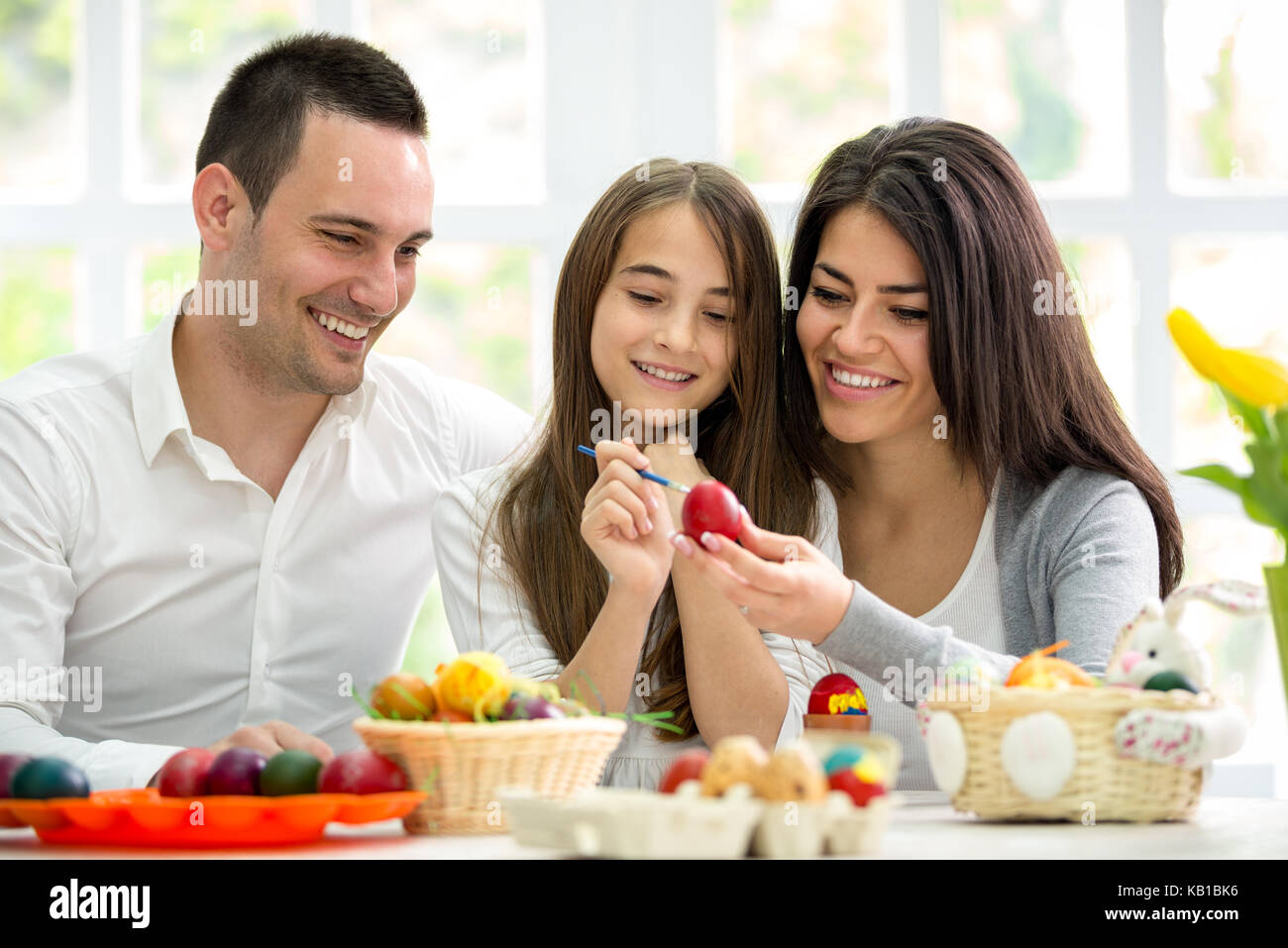 Easter family together decorate eggs Stock Photo - Alamy