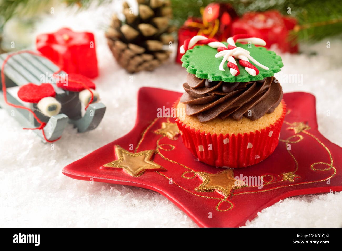 festive cupcake on decorative red plate Stock Photo - Alamy