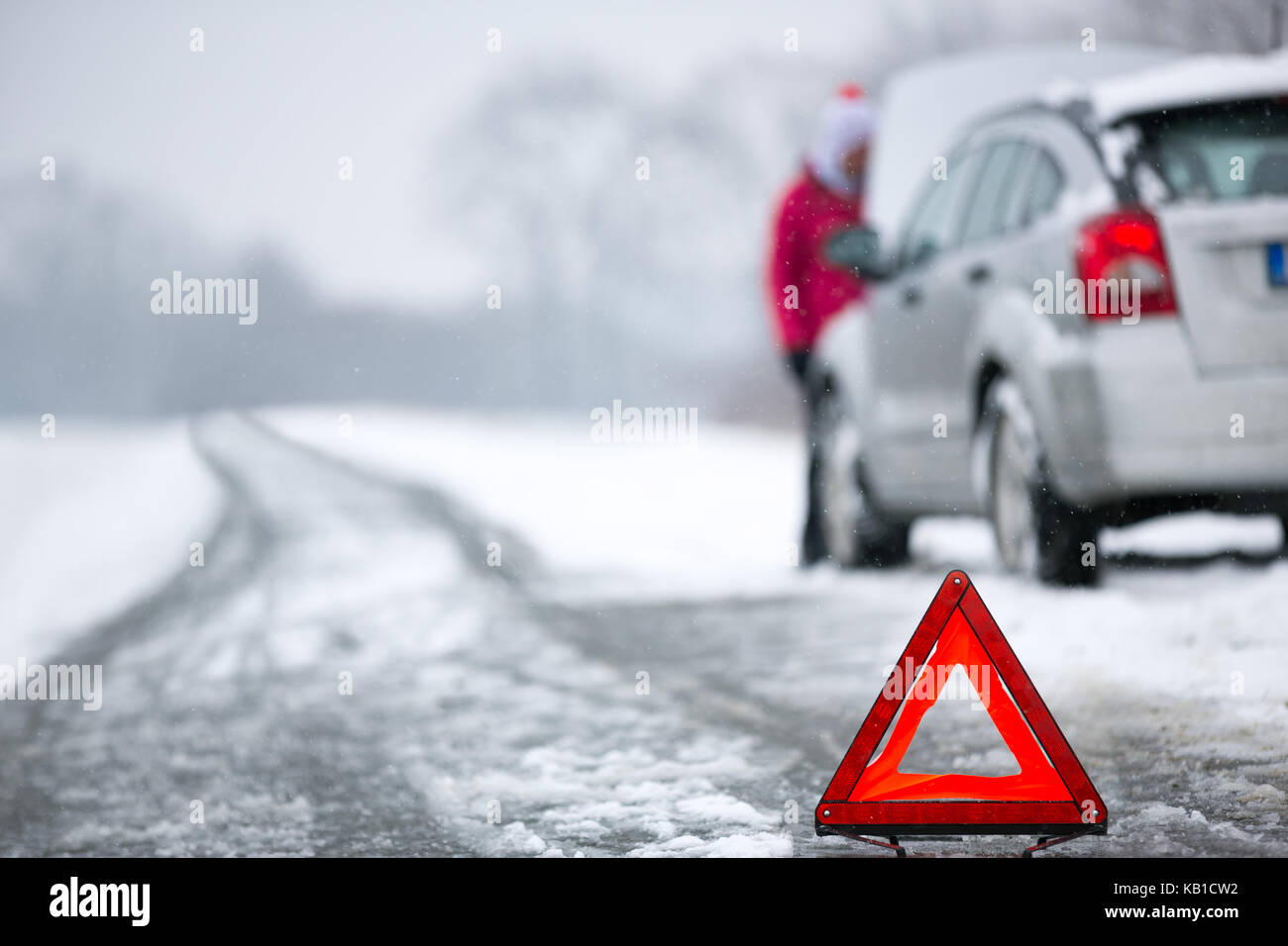warning triangle with winter car breakdown in background Stock Photo ...