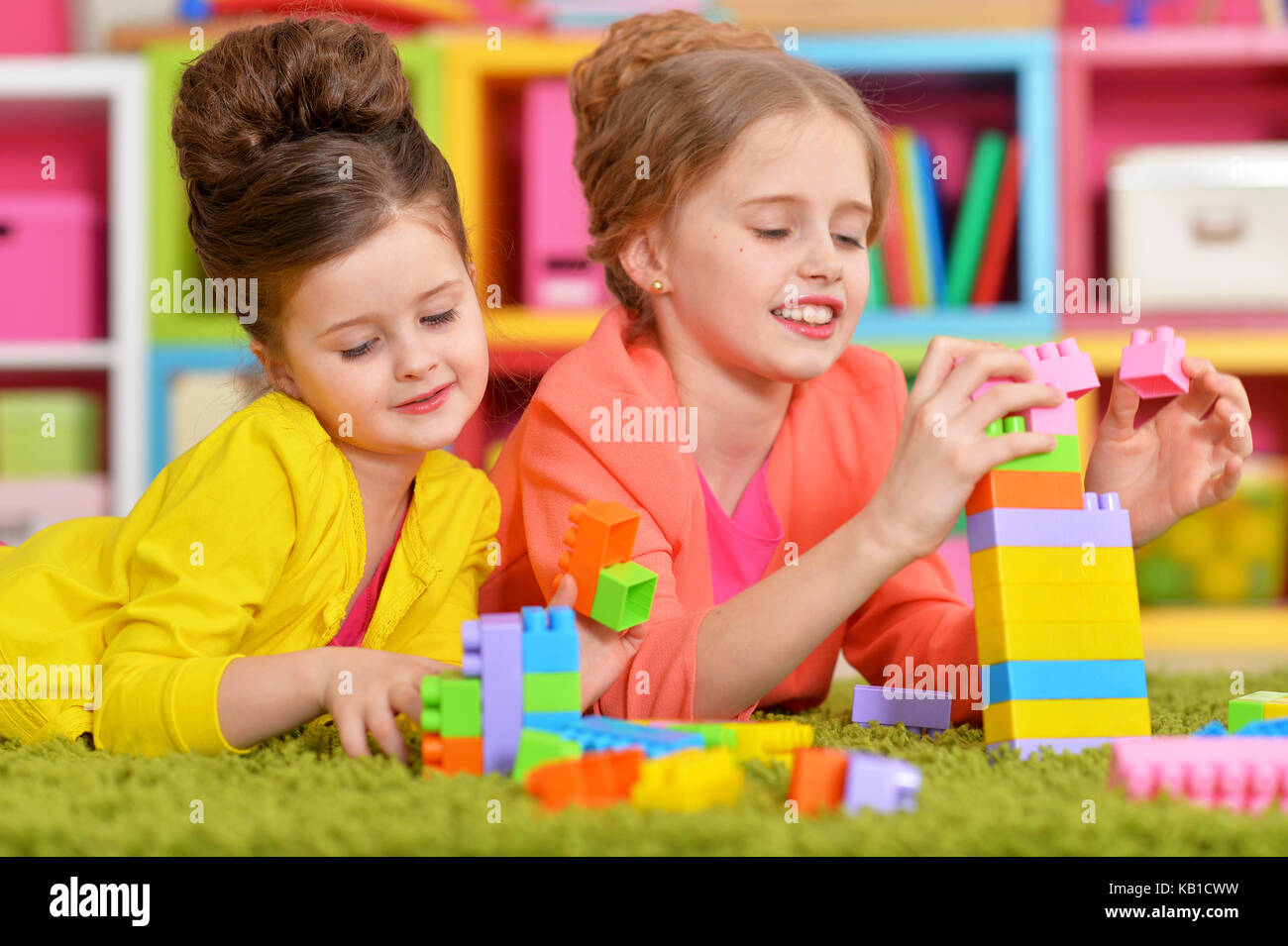 girls playing with colorful blocks Stock Photo - Alamy