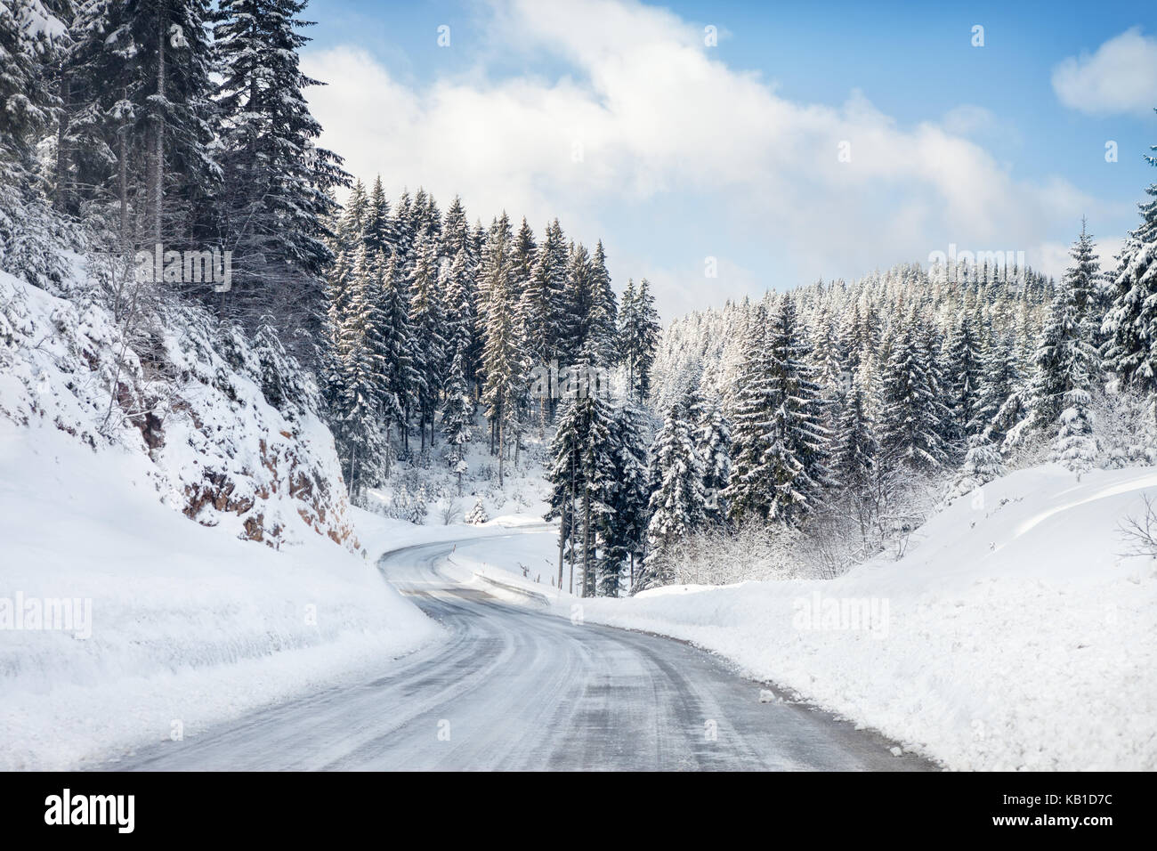 Empty snow covered road Stock Photo - Alamy
