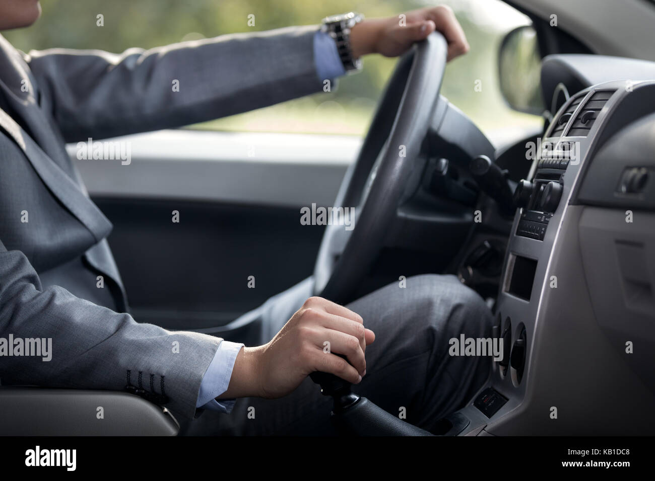 man driving car with hand on gearbox Stock Photo - Alamy