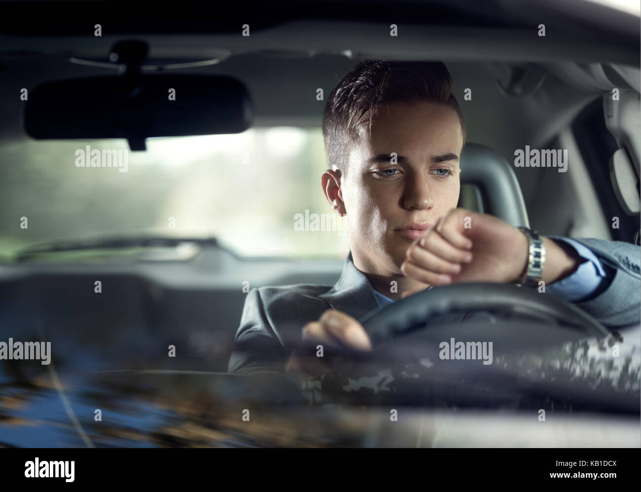 Fashionable young attractive man driving his car Stock Photo - Alamy