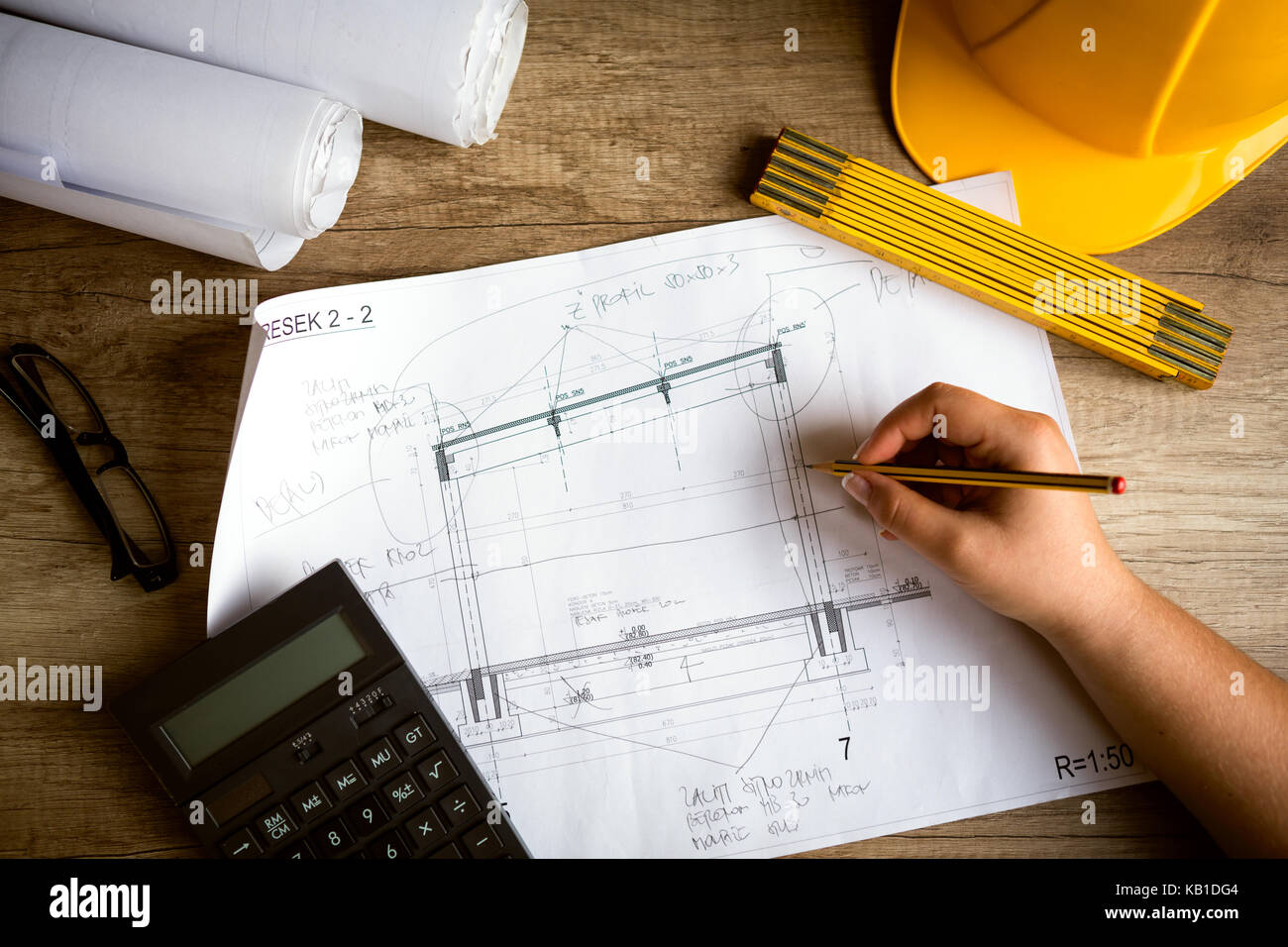 typical engineer workplace with blueprint, hardhat and measuring tools ...