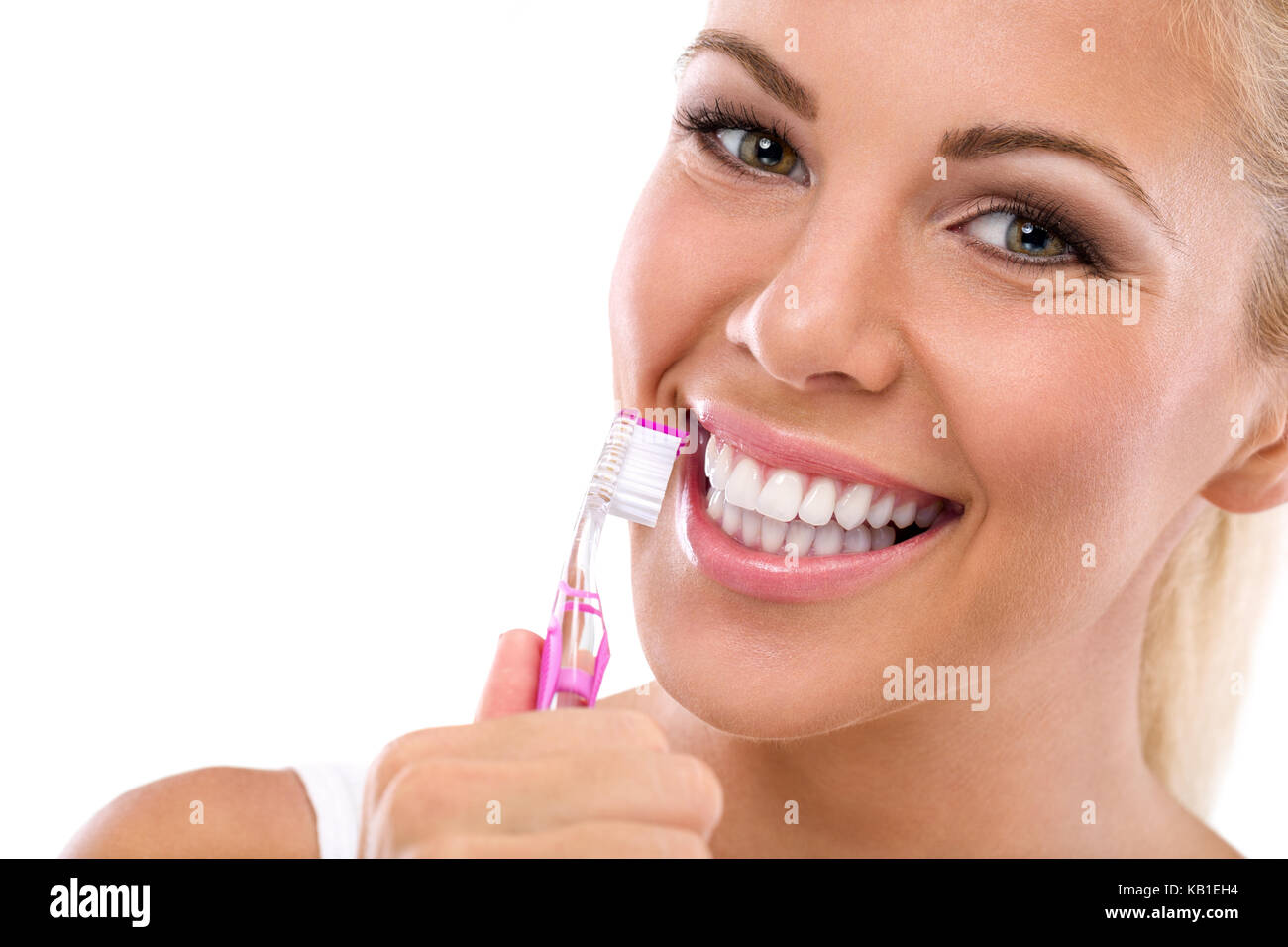 Smiling young woman with healthy teeth holding a tooth-brush Stock ...