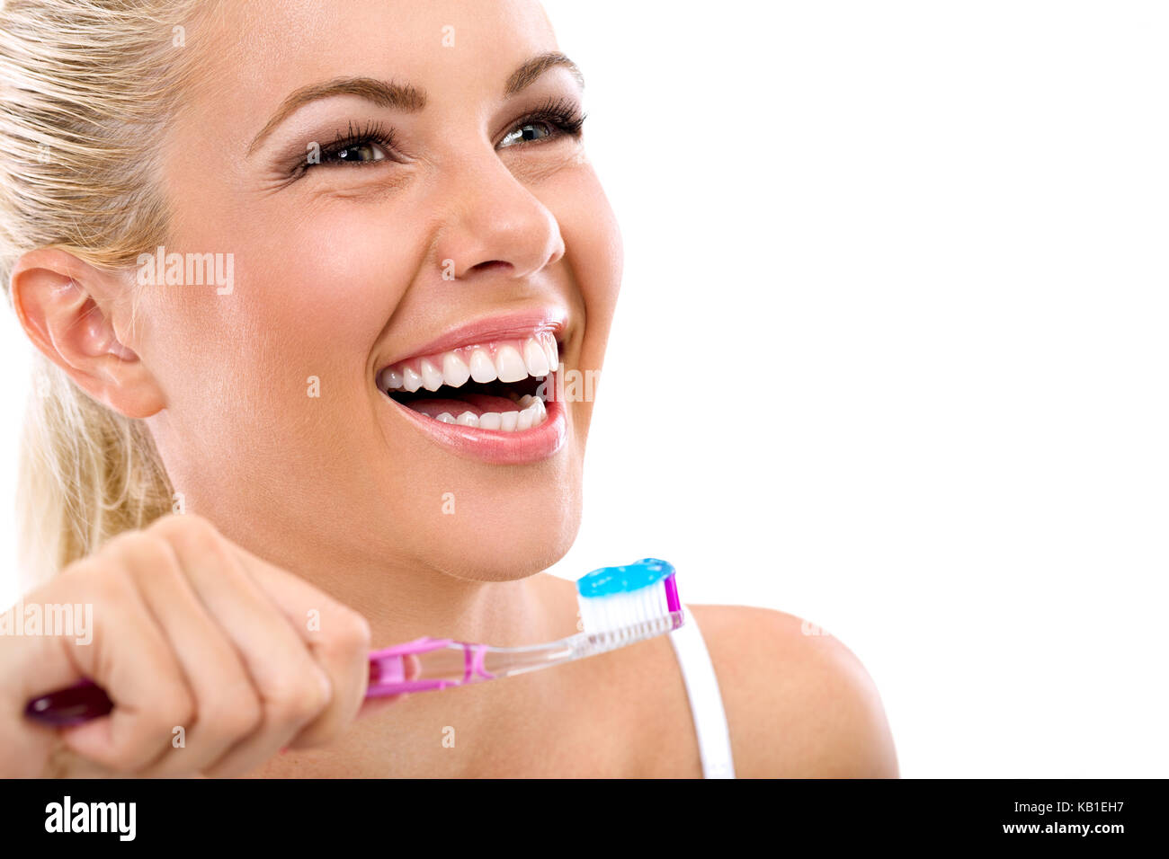 Laughing young woman with healthy teeth holding a tooth-brush Stock ...