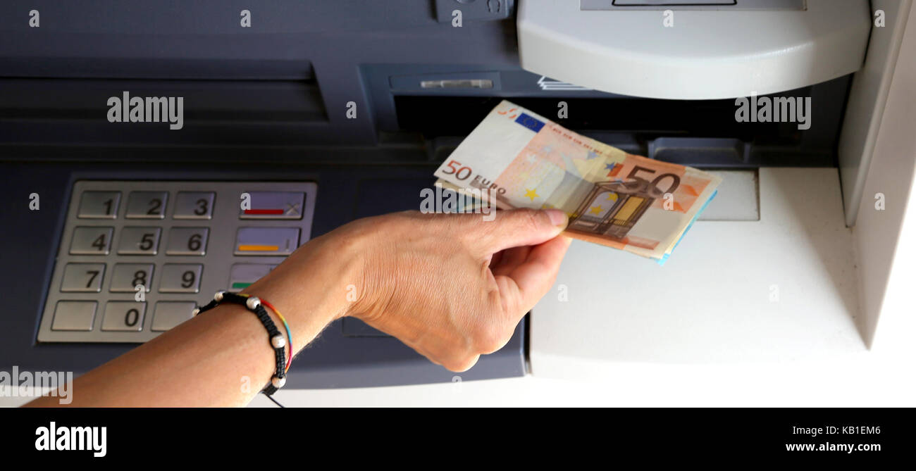 Hand withdrawing banknotes from atm hi-res stock photography and images ...