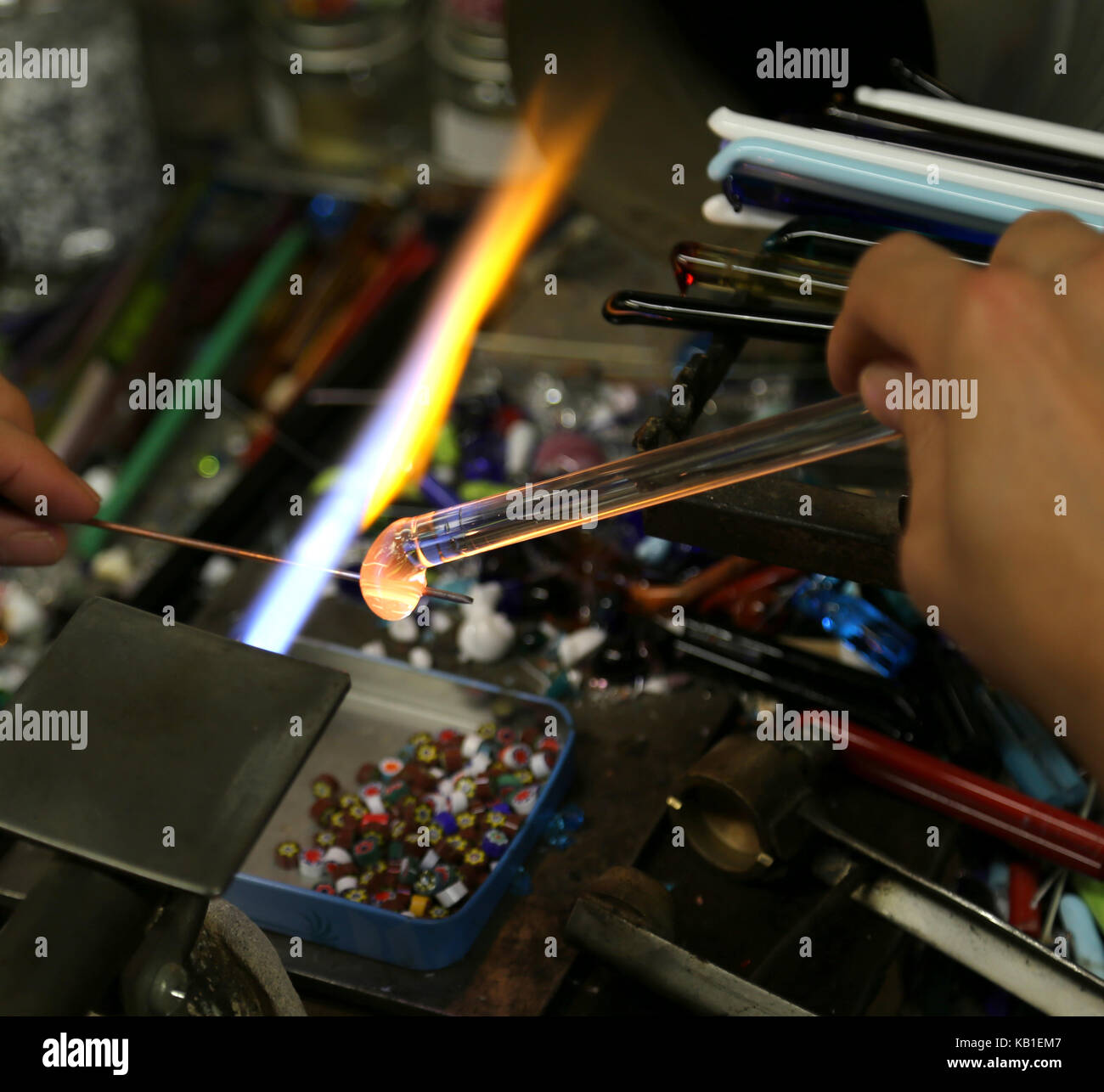glassworker works with hot flame in the workshop in italy Stock Photo ...