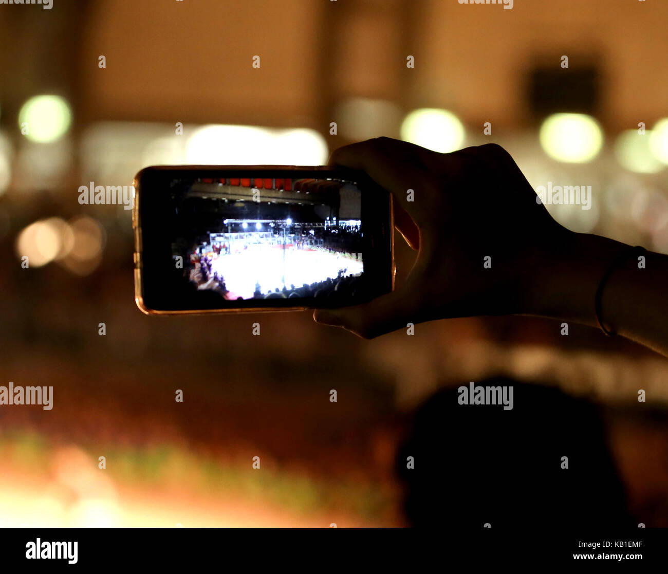 hand with the modern smartphone while shooting a video of a show Stock ...