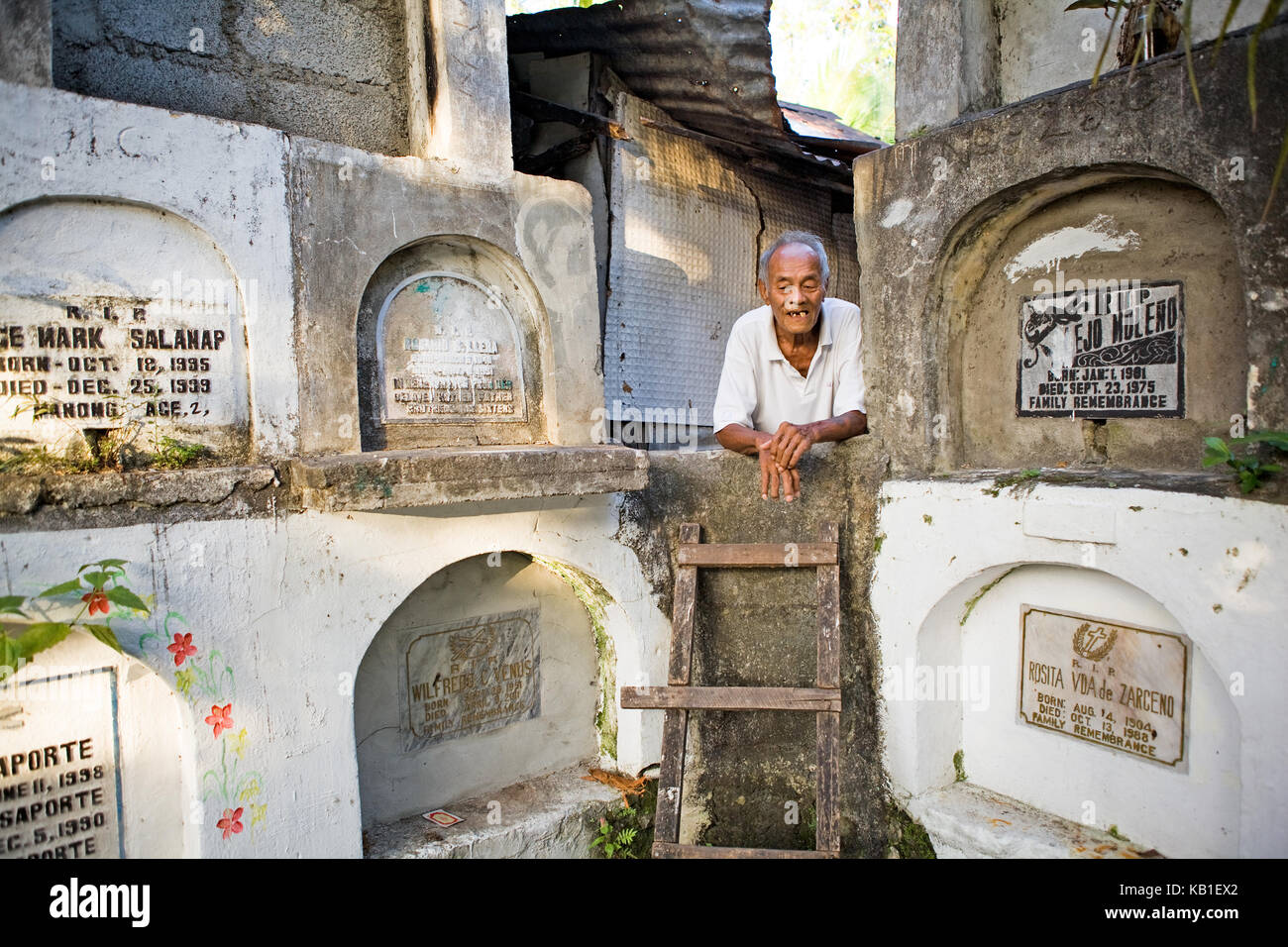 A homeless and poor elderly Filipino man lives among stacked concrete ...