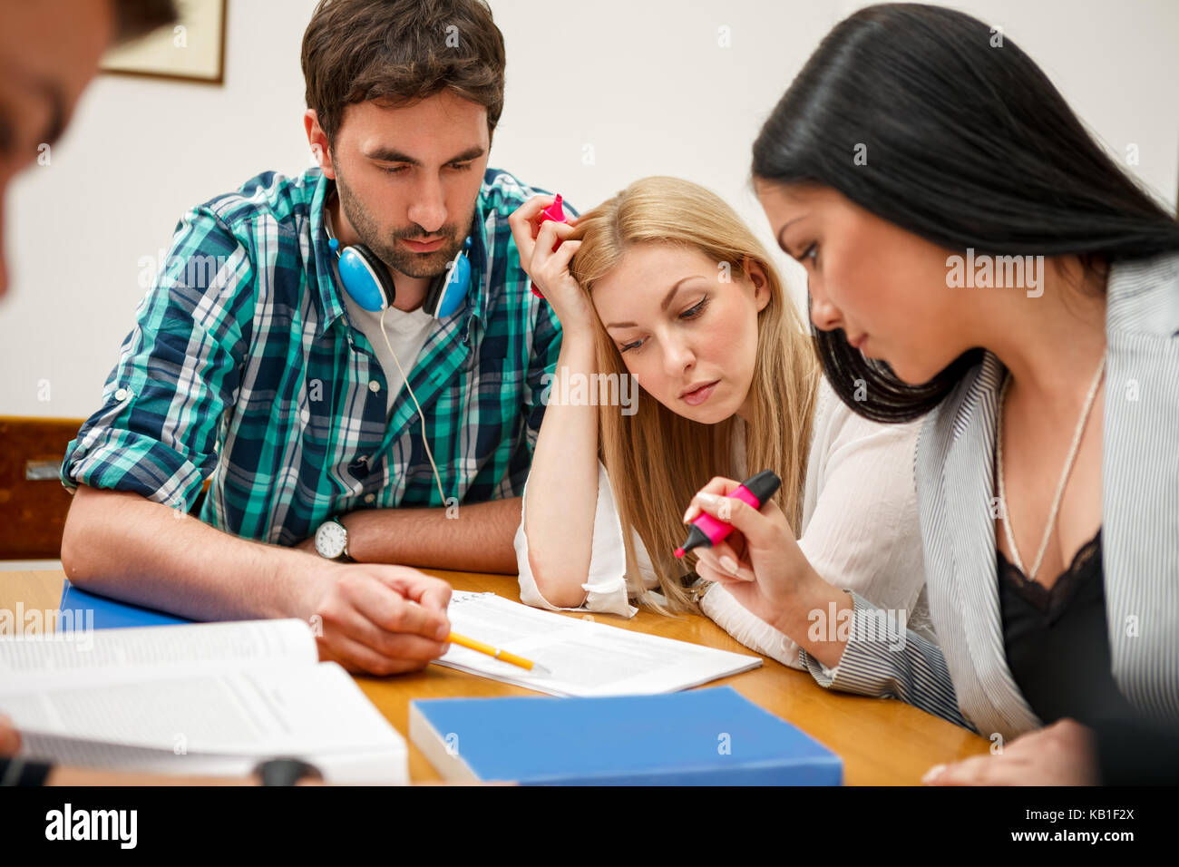 Group of students studying together at the classroom Stock Photo - Alamy