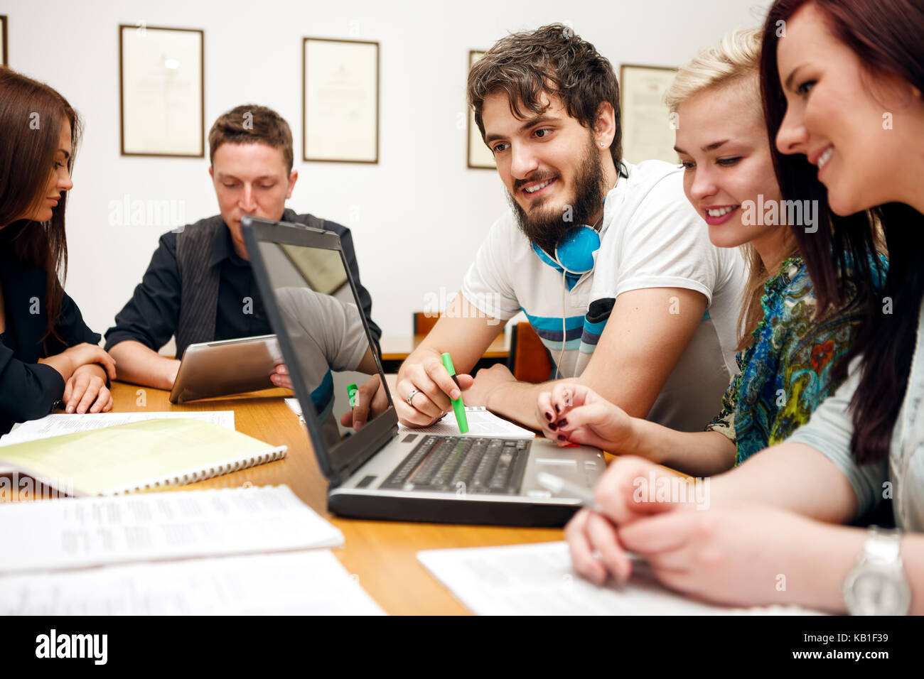 Cheerful students with laptop in a classroom Stock Photo - Alamy