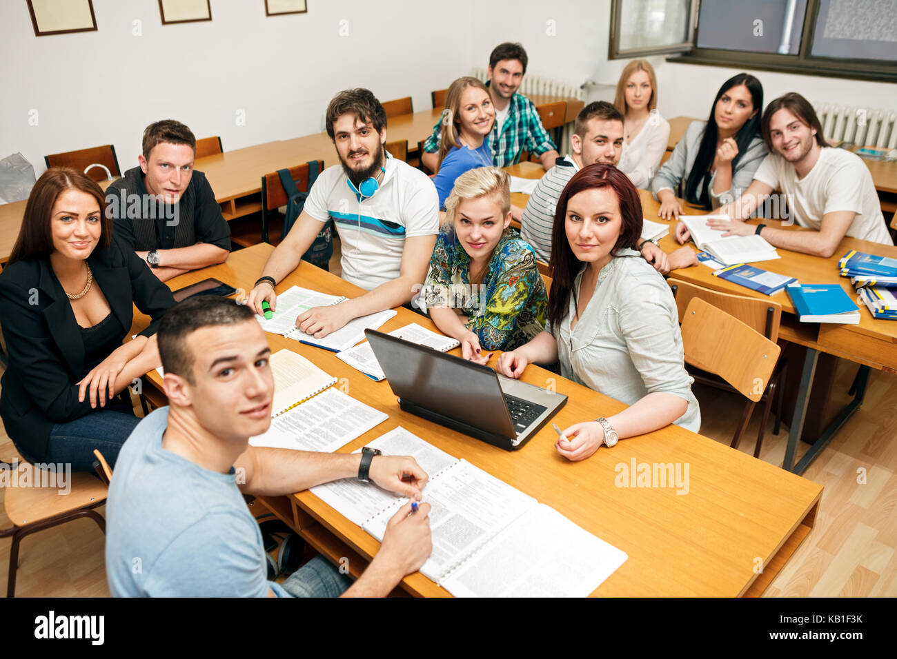 Happy students in a classroom in university class Stock Photo - Alamy