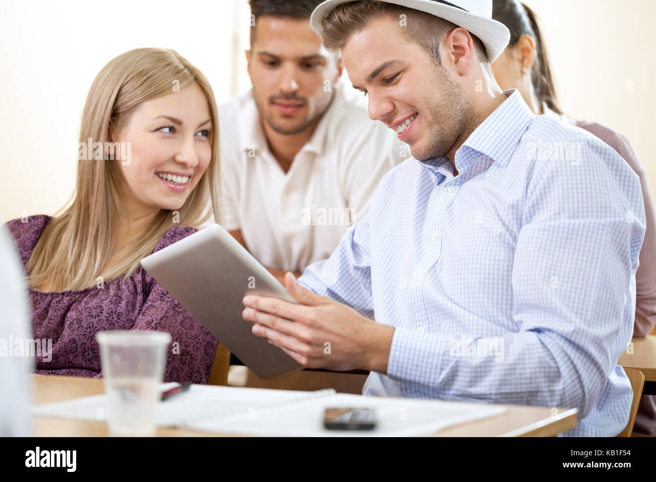 Male student showing his tablet university colleagues Stock Photo - Alamy