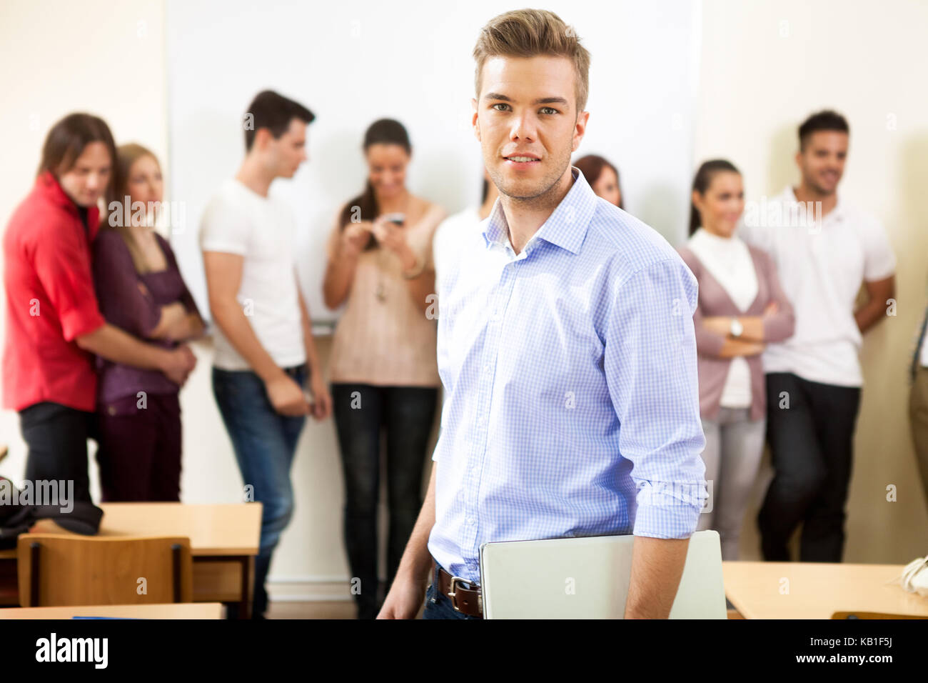 young, handsome college student with group of students in background ...