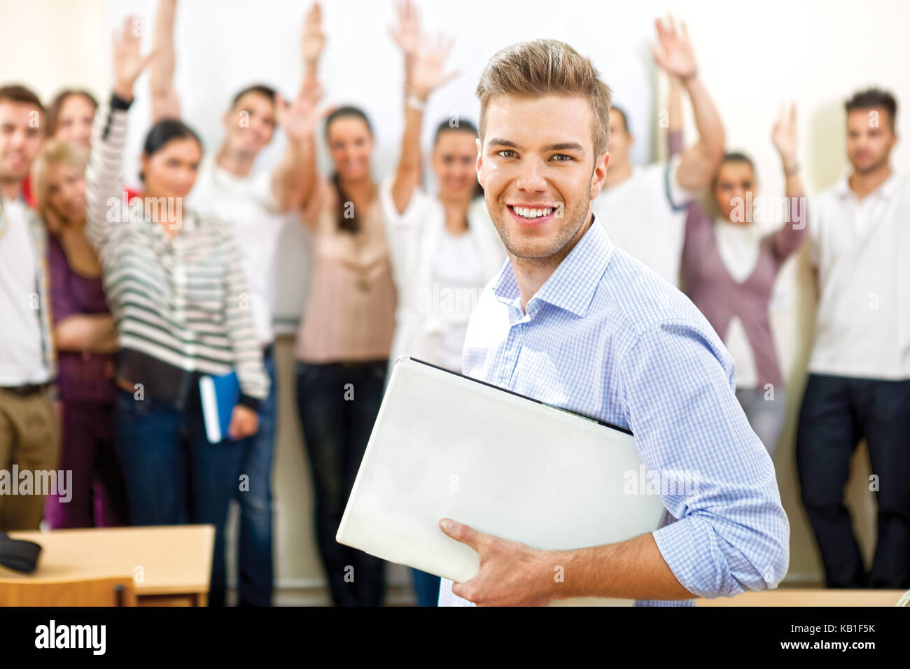 young, handsome college student with group of students in background ...