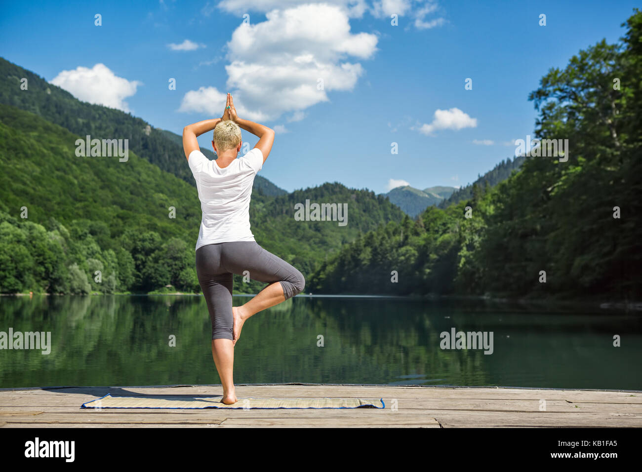 woman meditating in nature, back view Stock Photo - Alamy