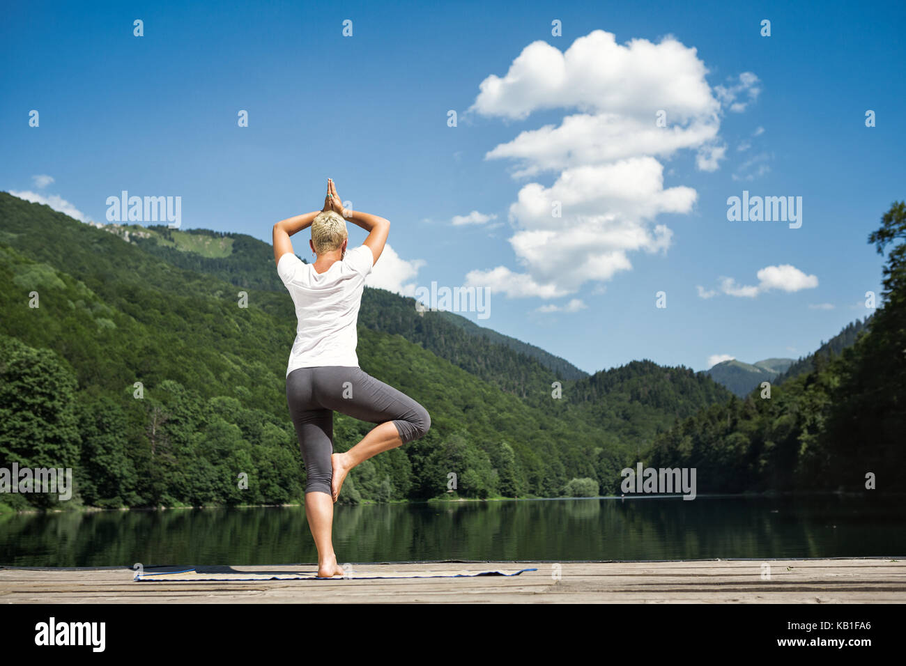 Young man yoga tree pose hi-res stock photography and images - Alamy