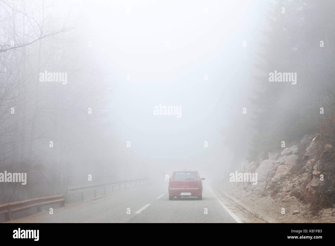 Foggy gray road, cars driving fading into the fog Stock Photo - Alamy
