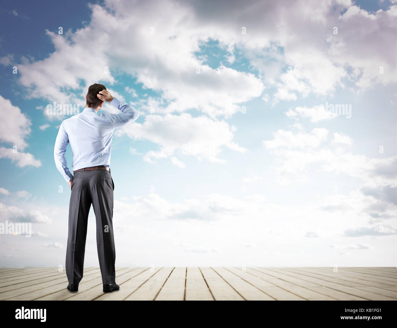 Back view of confident businessman looking at sky Stock Photo - Alamy