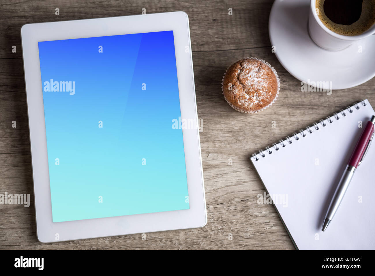 ipad Tablet with cup of coffee and empty paper over wooden background ...