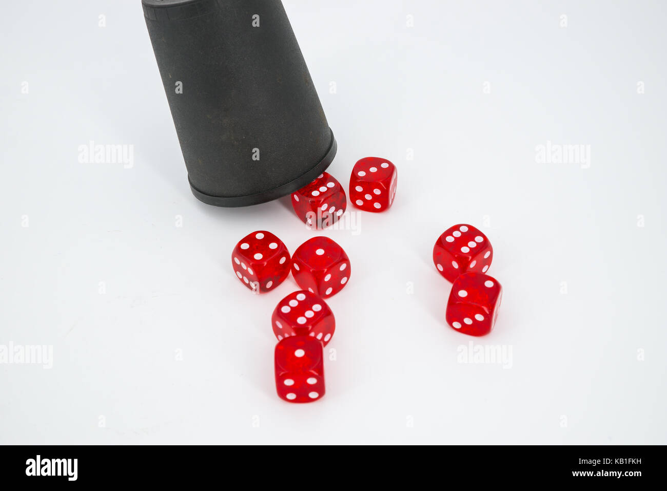 red dices and a cup isolated on white background Stock Photo - Alamy