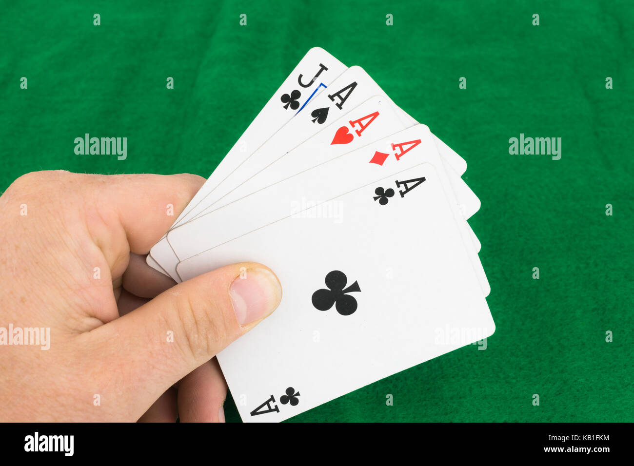 Poker Hand four aces infront of a green backgound Stock Photo - Alamy
