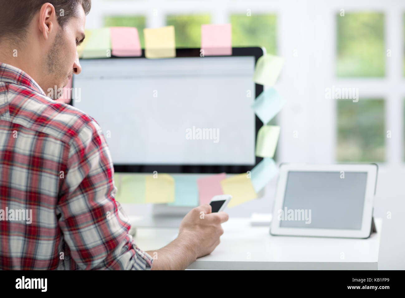 Man front of monitor with sticky notes on it Stock Photo - Alamy