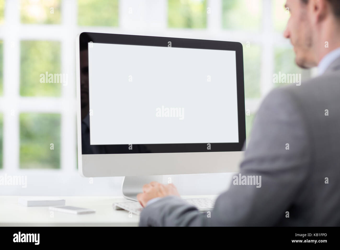 Businessman front of empty computer screen Stock Photo - Alamy