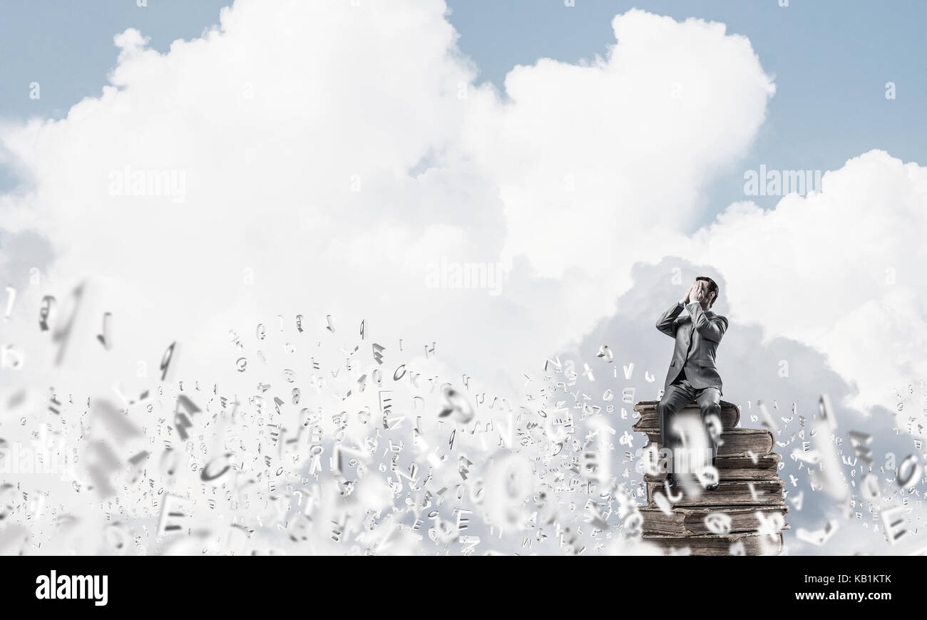 Young man floating in sky and do not want to see anything Stock Photo ...