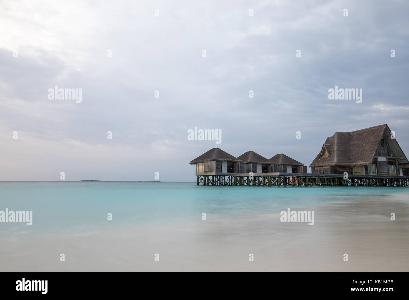 Traditional wooden huts at sunrise. Maldives Stock Photo - Alamy