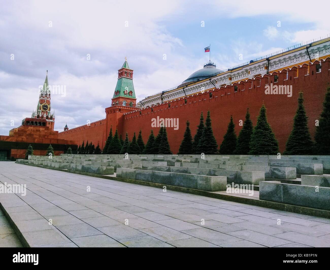 The red wall of the Moscow Kremlin with firs growing along it Stock ...