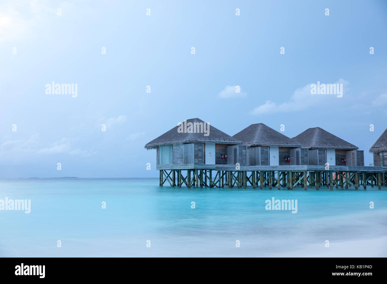 Traditional wooden huts at sunrise. Maldives Stock Photo - Alamy