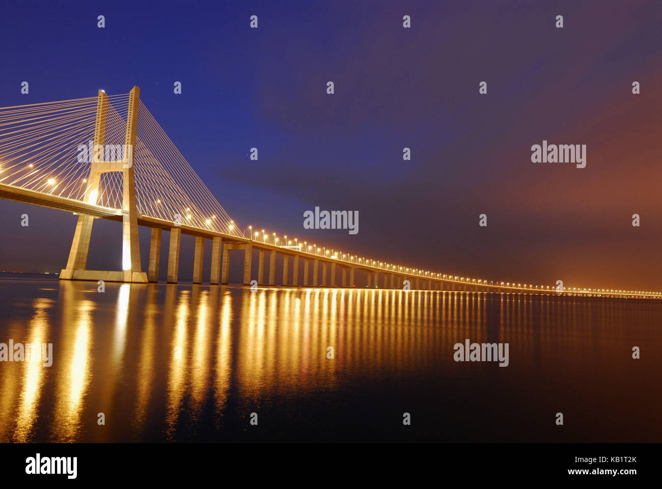 Portugal, Lisbon, diagonal rope bridge Ponte Vasco da Gama by night ...