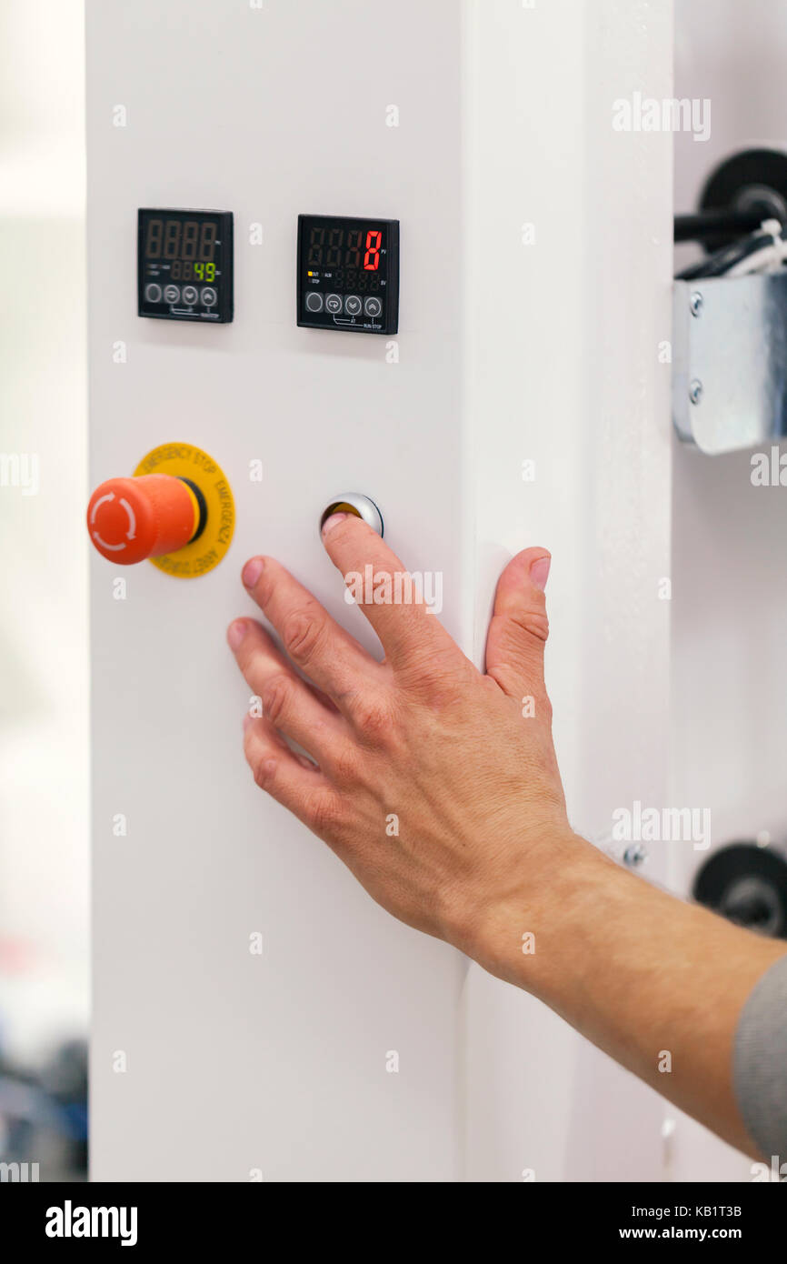 emergency stop red button with key on machine Stock Photo - Alamy