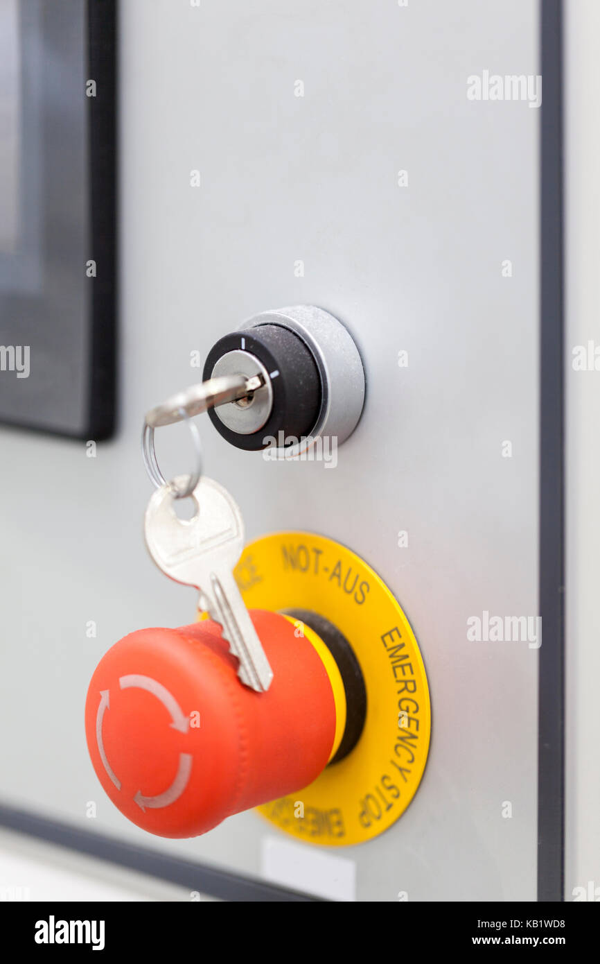 emergency stop red button with key on machine Stock Photo - Alamy