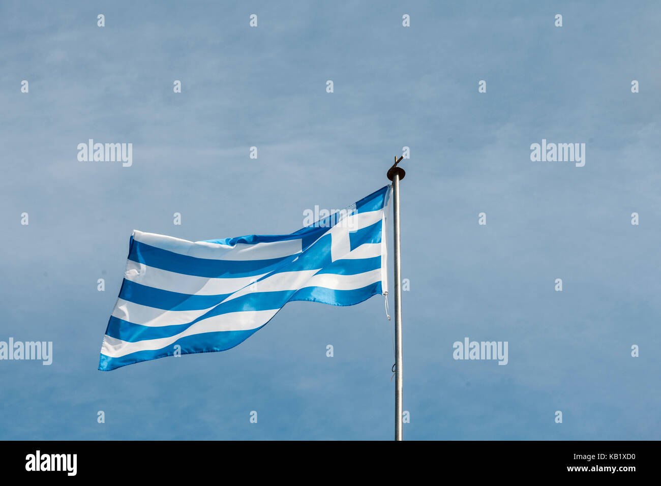 Greek flag on a flagpole against the blue sky Stock Photo - Alamy