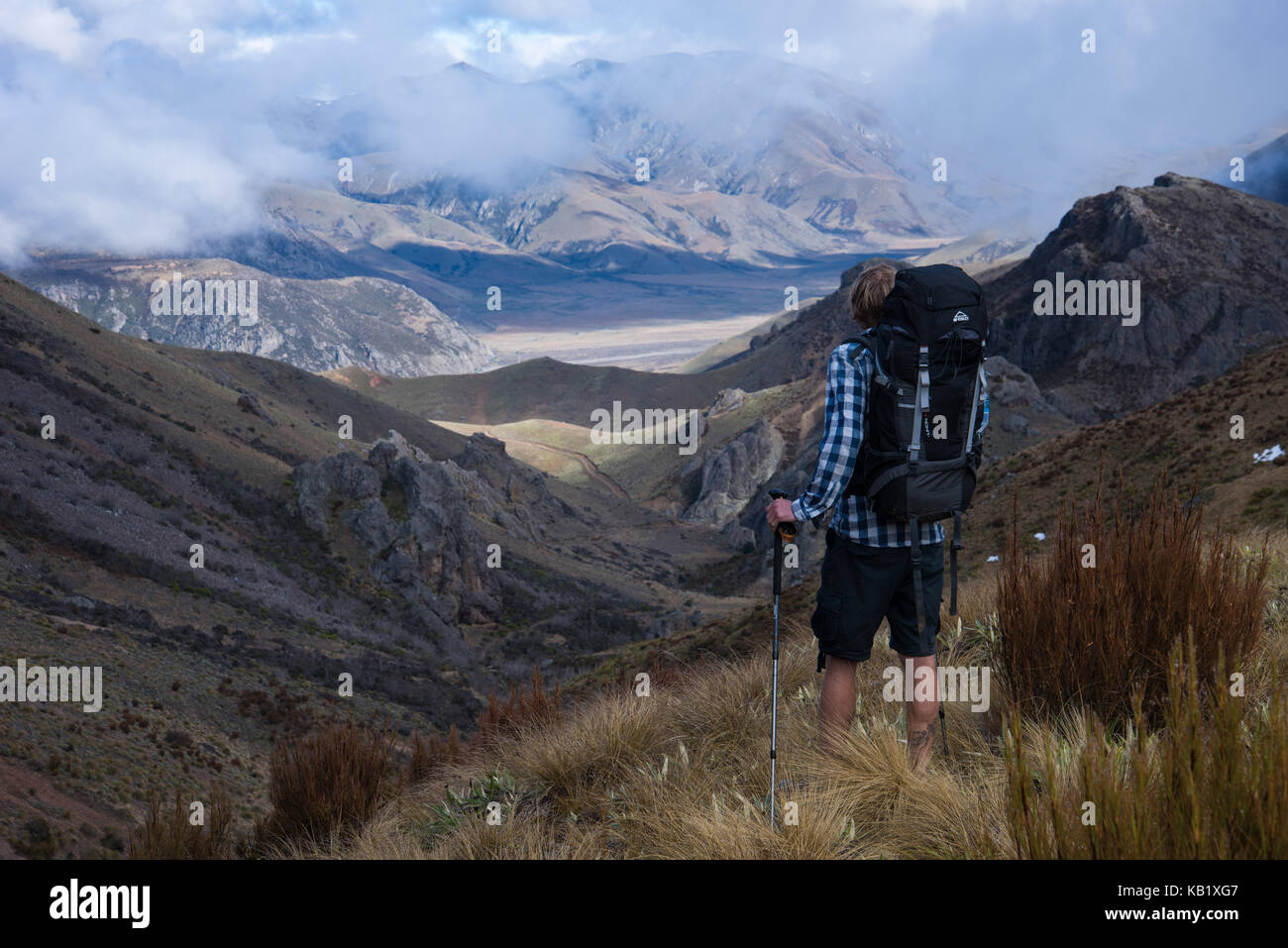 man looking over valley landscape Stock Photo - Alamy