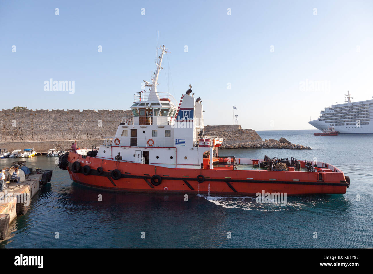 A tugboat working in the harbour of Rhodes in Greece, helping dock ...