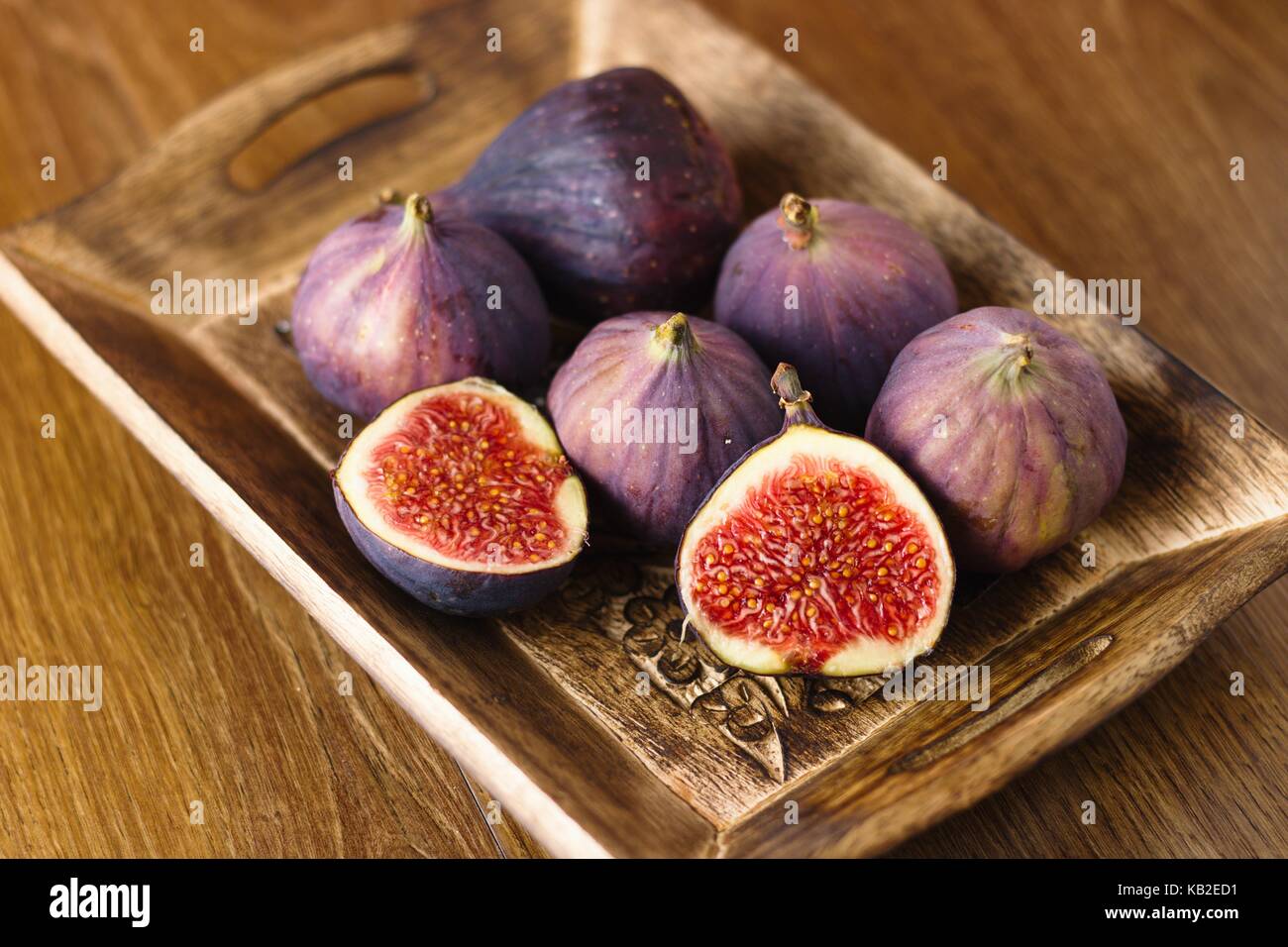 Beautiful ripe figs in rustic decorated wooden bowl Stock Photo - Alamy