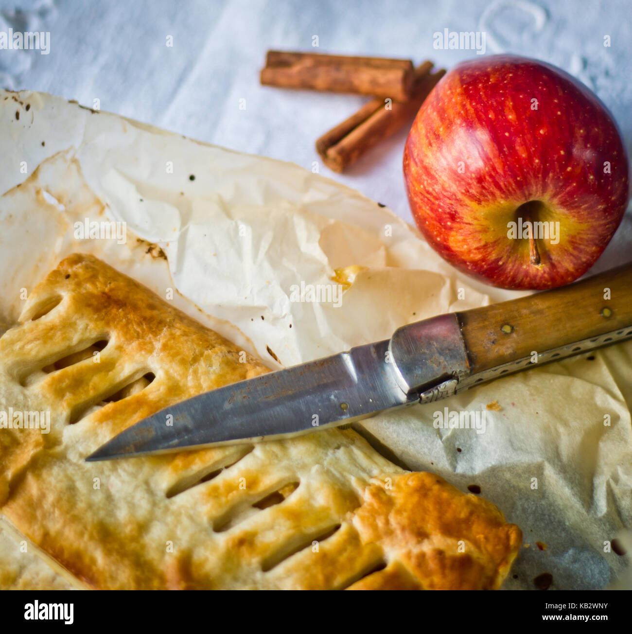 strudel homemade pie with apples and cinnamon, cut with a knife lying ...