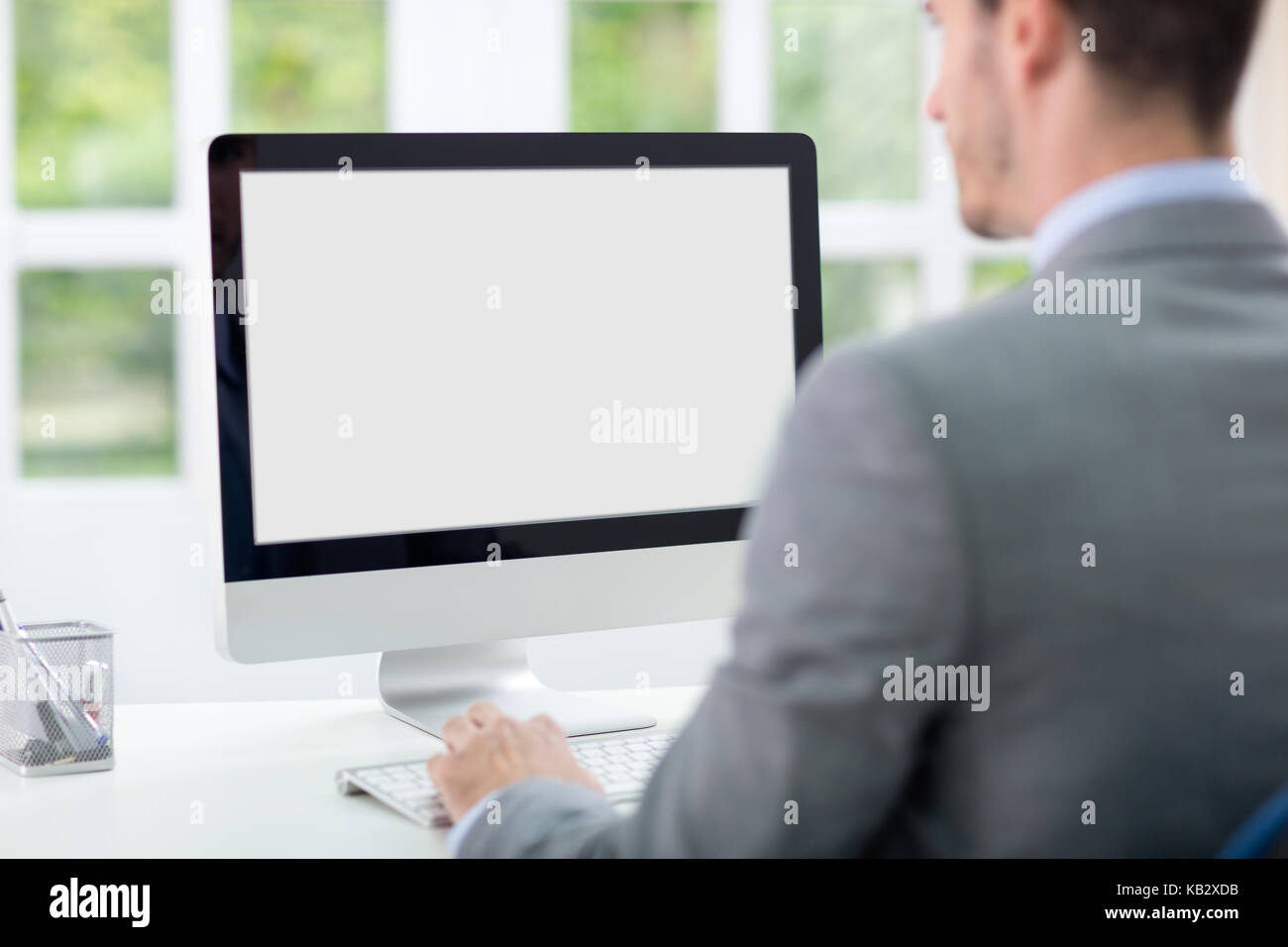 Businessman looking at computer screen Stock Photo - Alamy