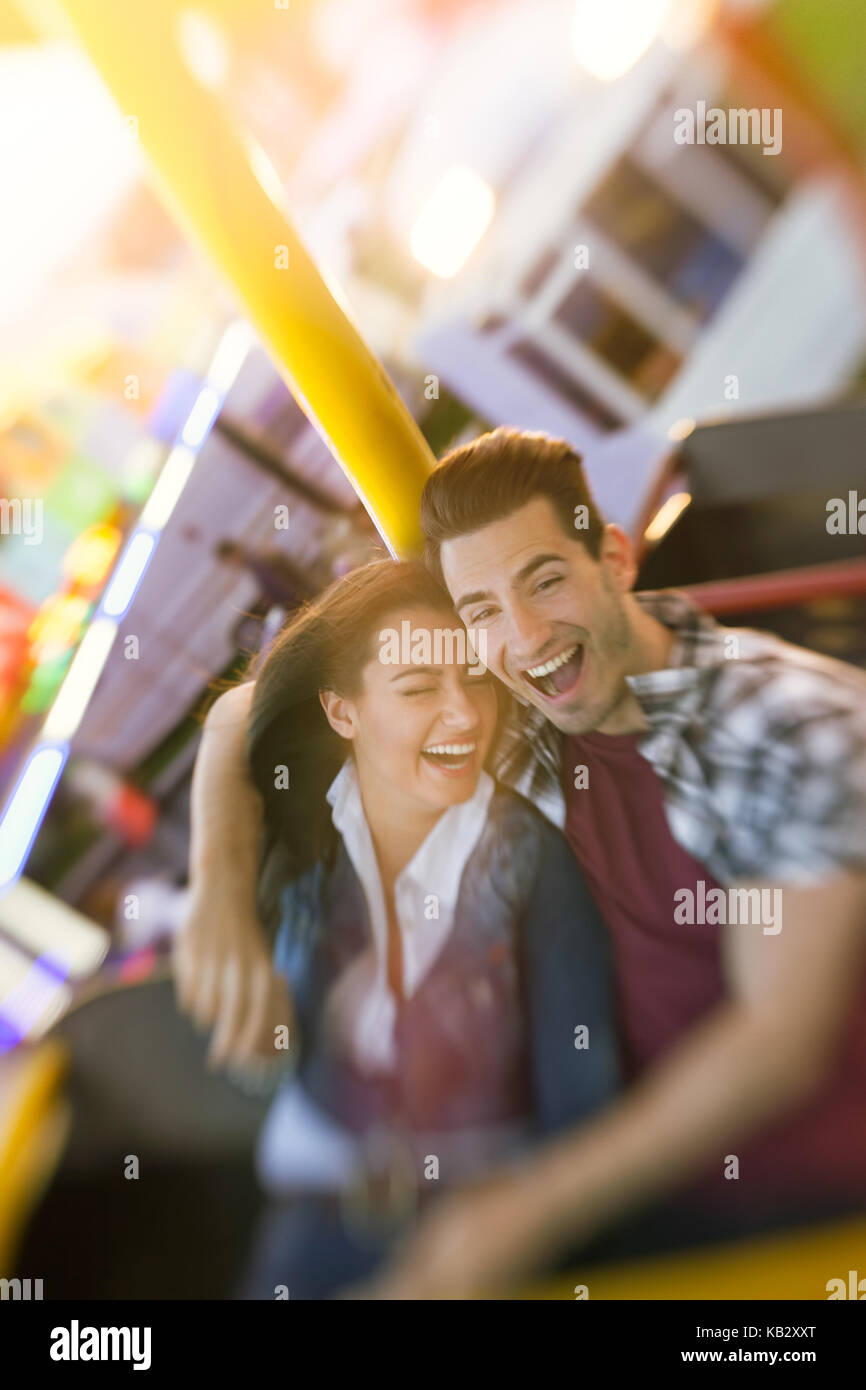 Happy couple enjoy in riding ferris wheel in attractions park - shoot ...