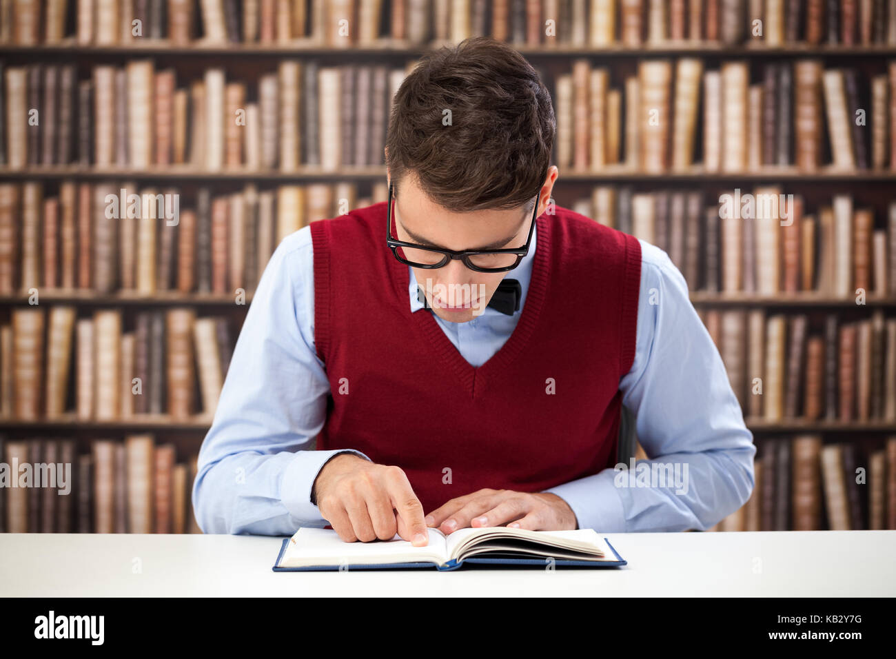 learning in library, focused student reading book Stock Photo - Alamy