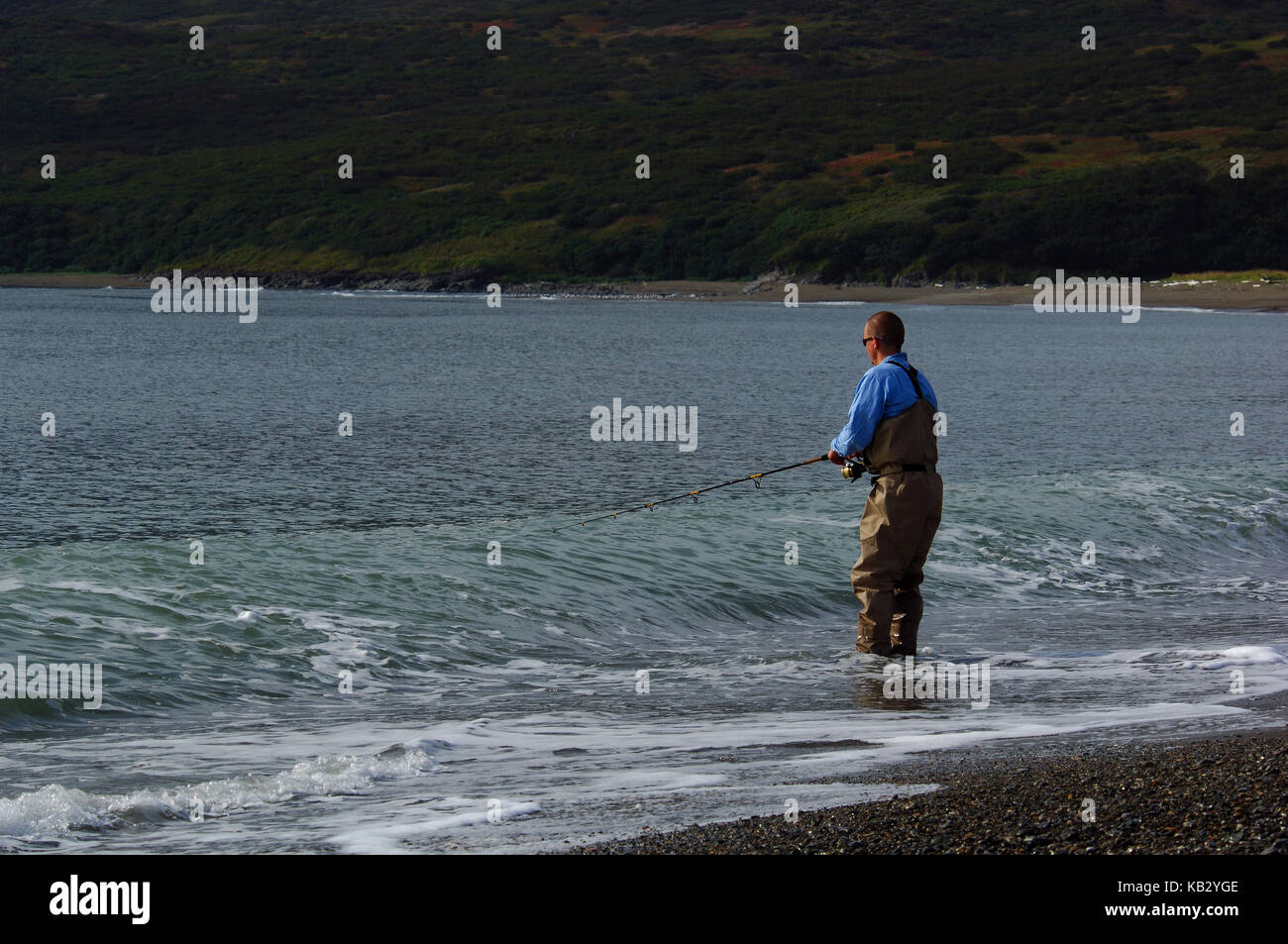 Angler fishing with a spinning rod for trout and salmon near Chignik ...
