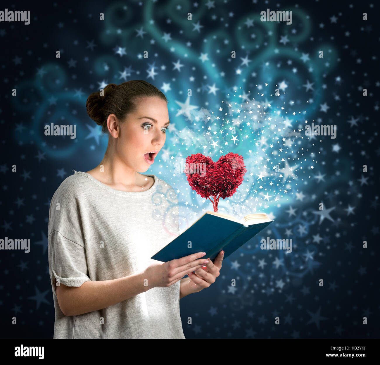 Young woman reading a magic book Stock Photo - Alamy