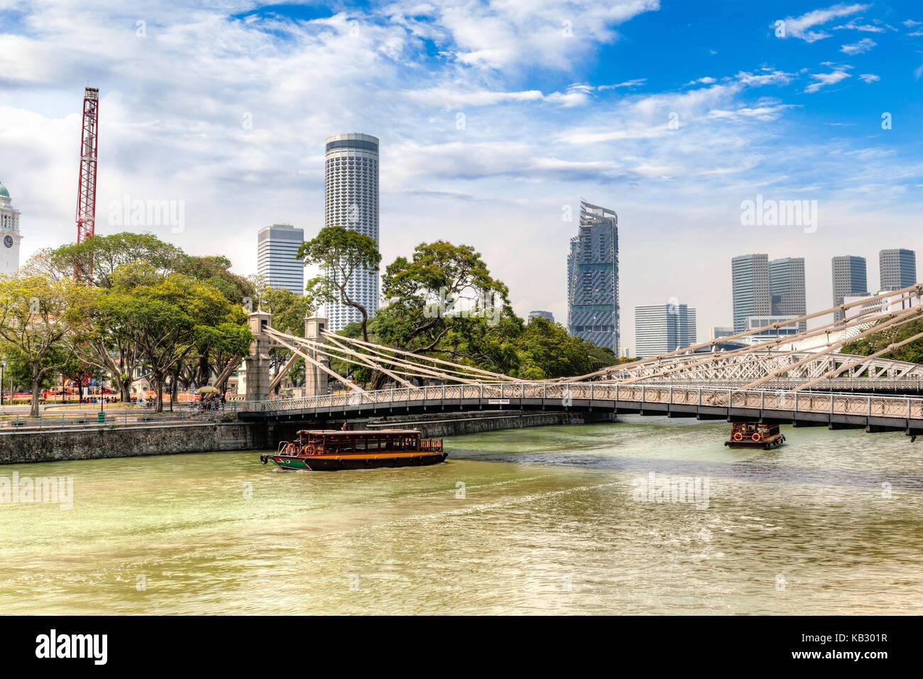 Bumboats ply the Singapore River on Boat Quay under Cavenagh Bridge ...