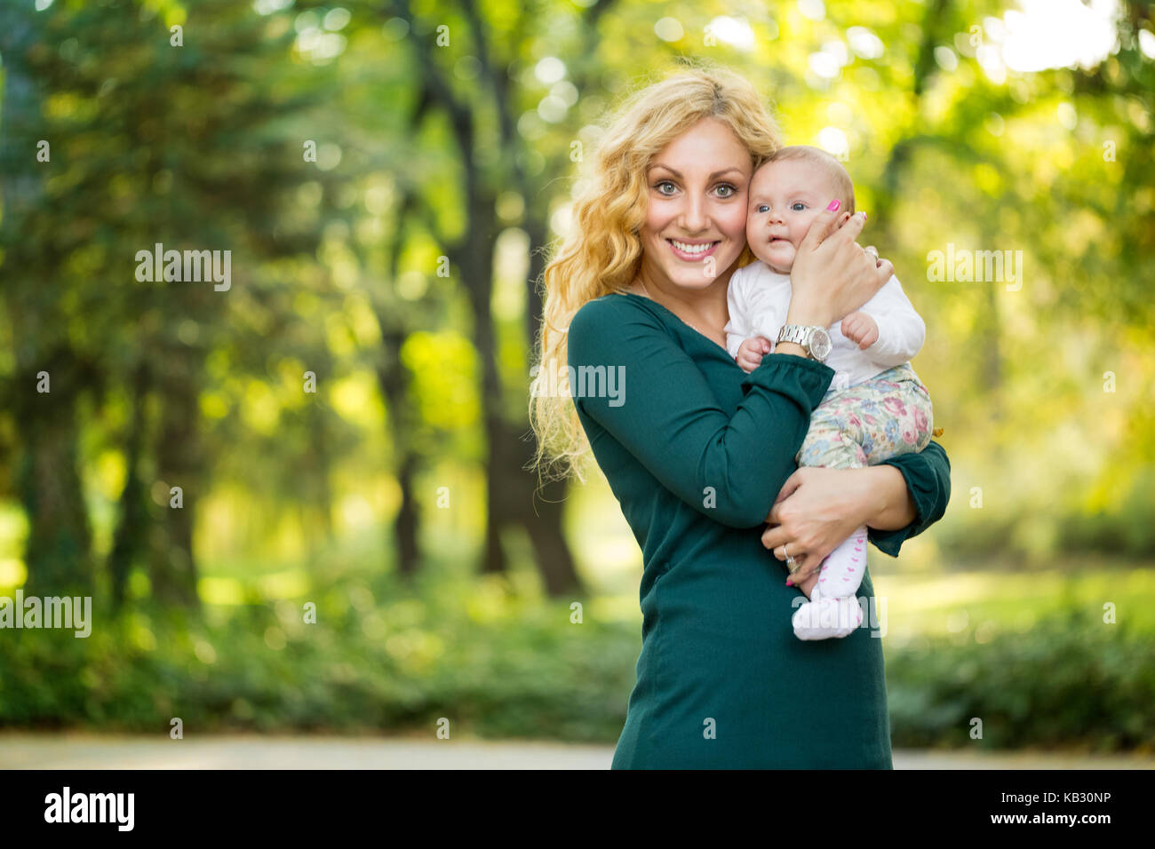 Young mom with baby, outdoor Stock Photo - Alamy