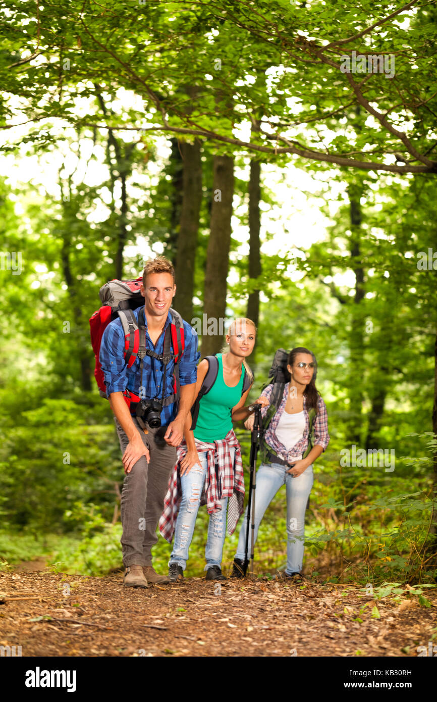 friends having fun hiking through the forest Stock Photo - Alamy